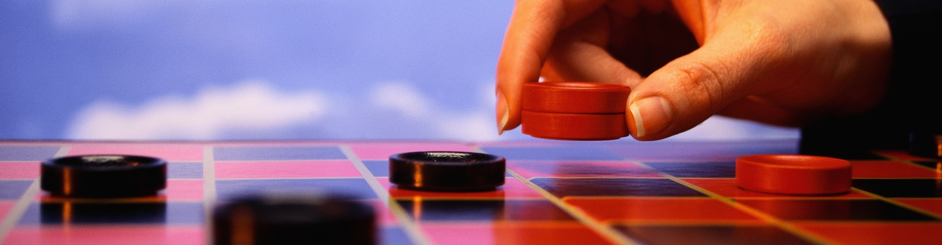 About Us - The Red Checker